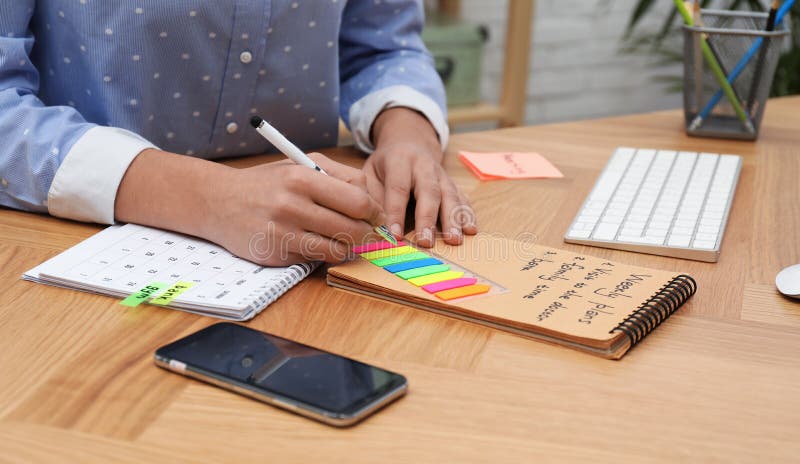 Woman Making Schedule Using Calendar at Table in Office Stock Photo ...