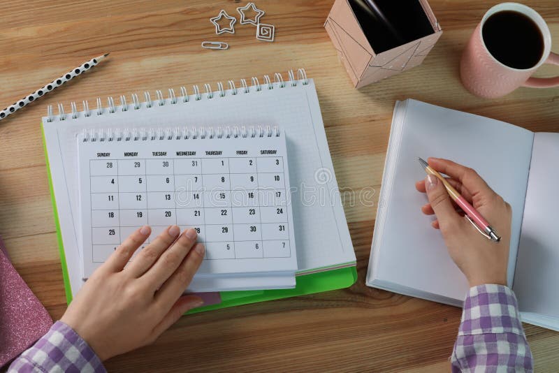 Woman Making Schedule Using Calendar at Table, Top View Stock Photo ...