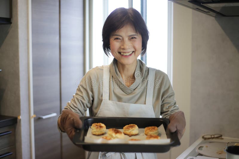 A woman making sweets stock image. Image of lifestyle - 325197443
