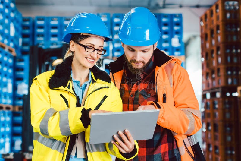 Woman and Man As Workers in Logistics Center Using Computer Stock Photo ...