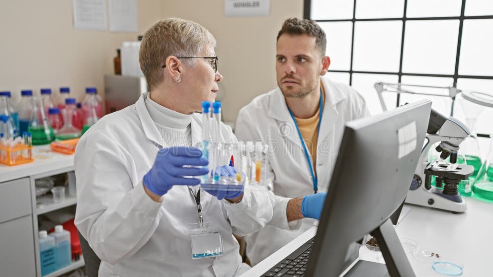 A Woman and Man, Both Scientists, Work Together in a Laboratory ...