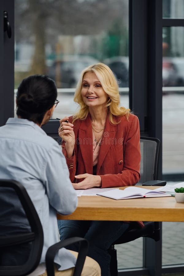 Woman and Man Conversing at Table Stock Image - Image of resumes ...