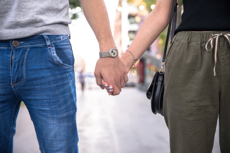 Woman and man hand in hand stock photo. Image of young - 210630726