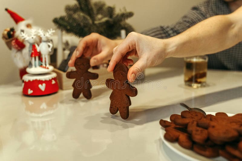 A Woman and a Man Play with Gingerbread Men on the Table during a Tea ...