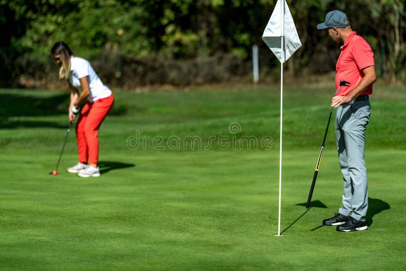 A Woman and a Man Playing Golf, Woman Putting Stock Image - Image of ...