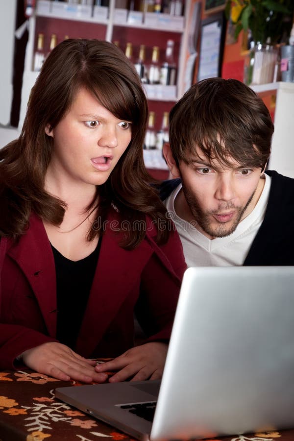 Woman and Man Staring with Shock at Laptop Stock Photo - Image of good ...