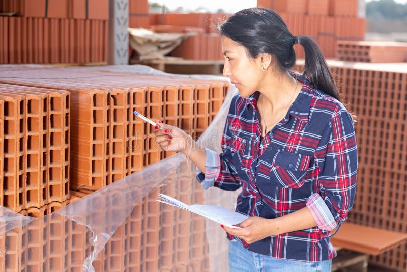Woman Manager Keeps Records of Building Materials in the Open Area of ...