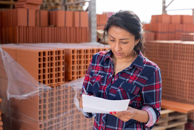 Woman Manager Keeps Records of Building Materials in the Open Area of ...