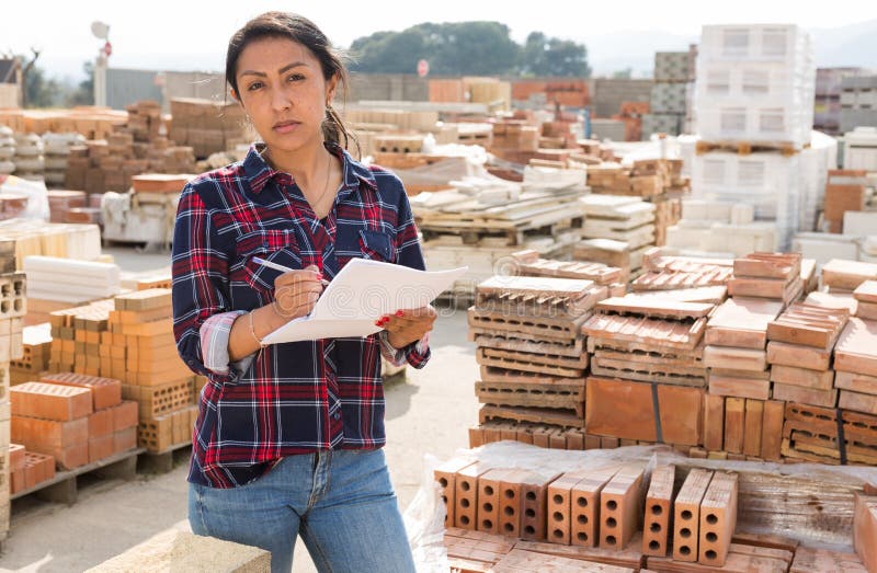 Woman Manager Keeps Records of Building Materials in the Open Area of ...
