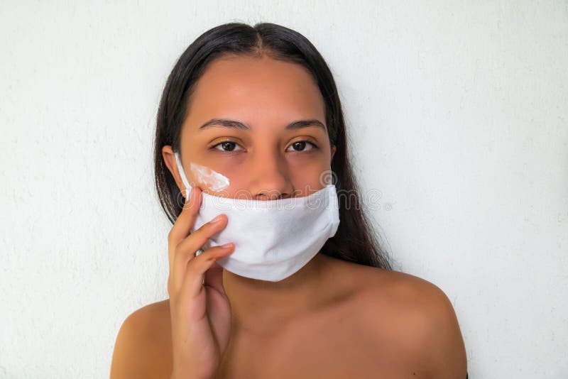 Woman with Mask Applying Cream on Her Face. Wearing Face Mask Stock ...