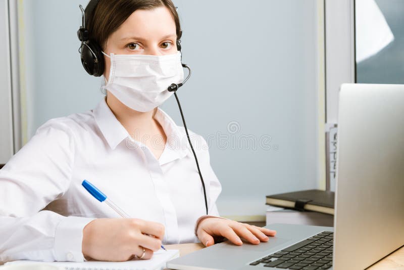 Woman in Mask with Headset, Using Computer and Notebook Stock Image ...