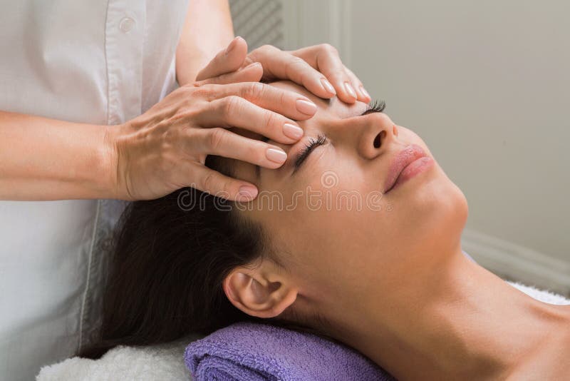 Woman Massagist Make Face Lifting Massage In Spa Wellness Center Stock