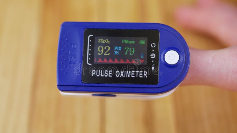 Woman Measures Pulse and Oxygen Saturation Using a Pulse Oximeter at ...