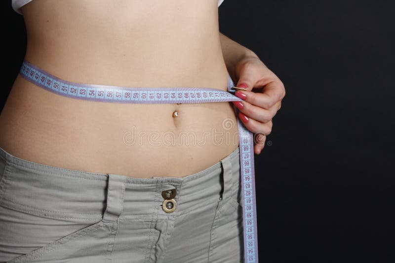 Woman measuring her waist stock photo. Image of woman - 14265052