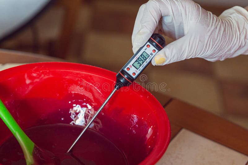 Woman is Measuring the Temperature of Pink Icing for a Mousse Cake ...