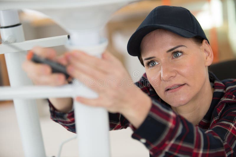 Woman Mechanic Fixing Chair Stock Photo - Image of profession, fixing ...