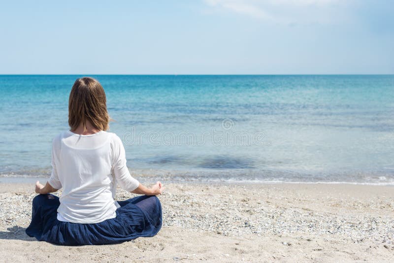 Woman Meditating at the Sea Stock Photo - Image of hand, lotus: 65536460
