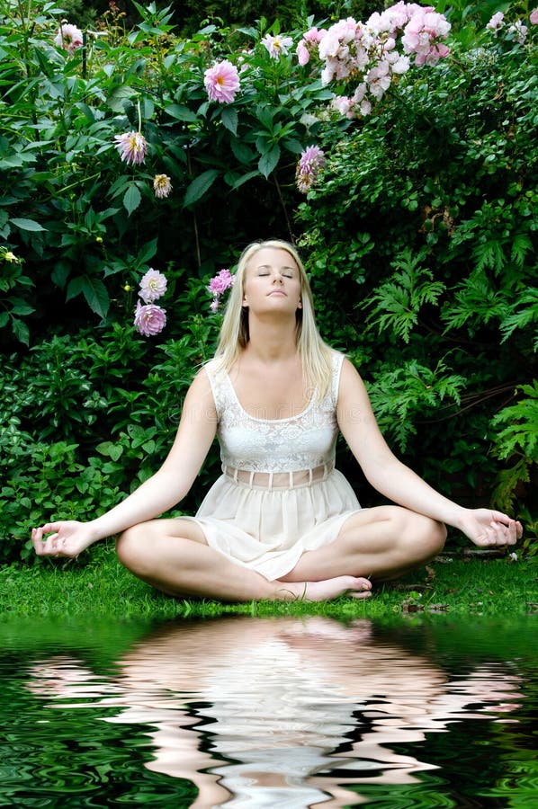 Woman in meditation pose stock photo. Image of garden - 23121596