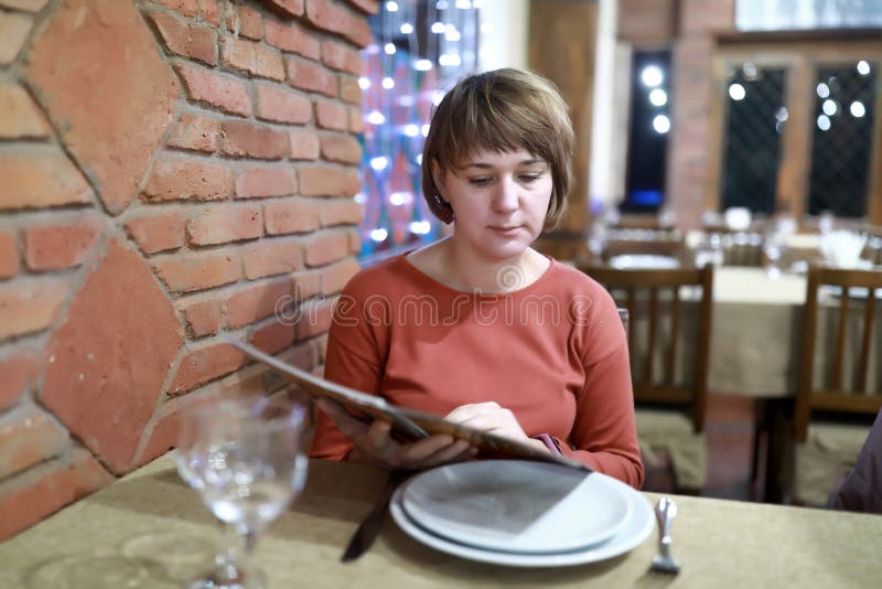 Woman with menu stock image. Image of upscale, decide - 2373401
