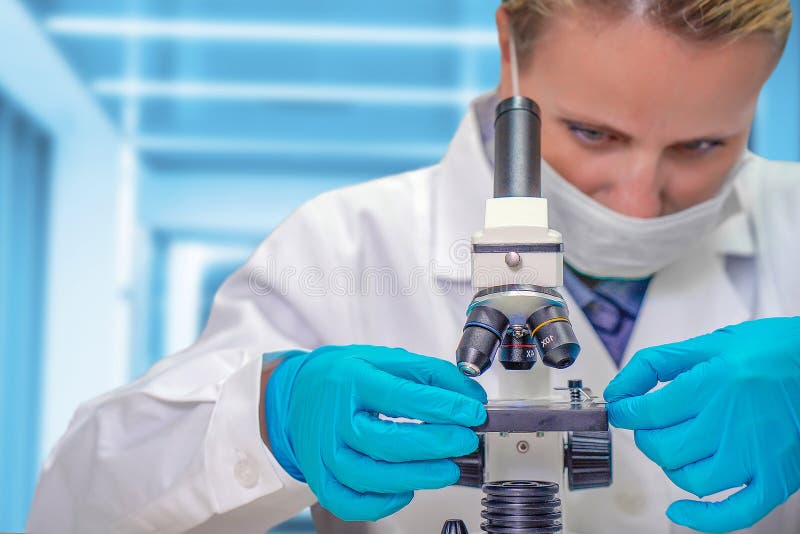 Woman with a Microscope. Scientist Looks at a Test Sample. Scientist ...