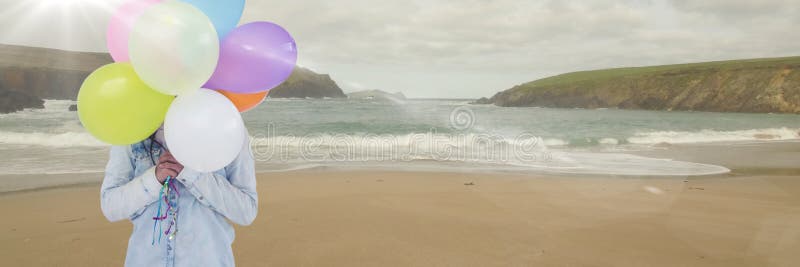 Woman Mid Section with Balloons on Beach with Flare Stock Photo - Image ...