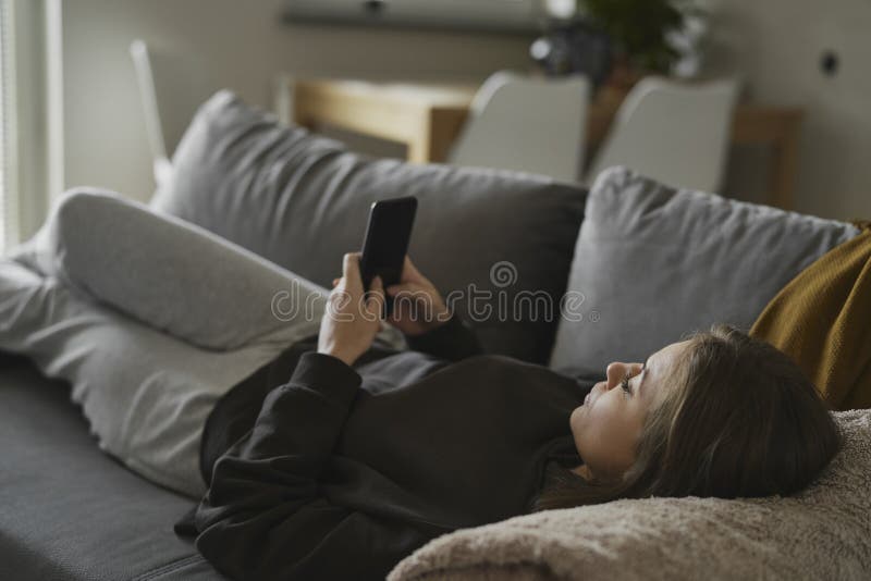 Woman with Mobile Phone at the Sofa Stock Image - Image of woman ...