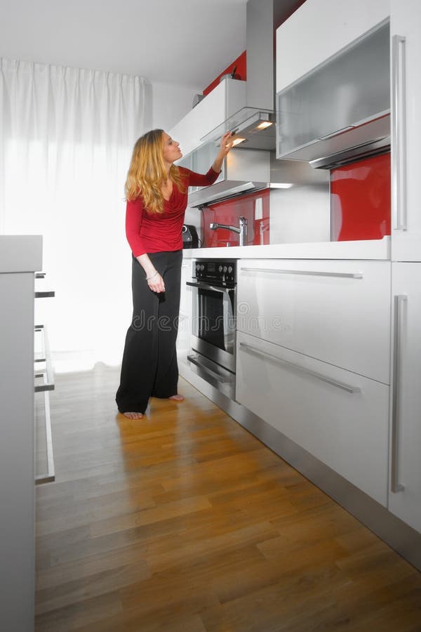 Woman in modern kitchen stock photo. Image of female - 10187982