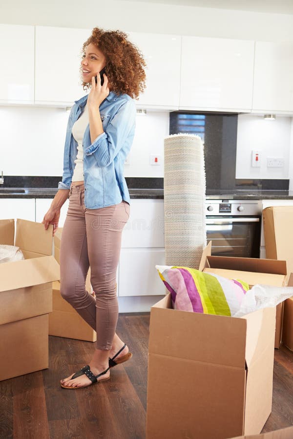 Woman Moving into New Home Talking on Mobile Phone Stock Image - Image ...