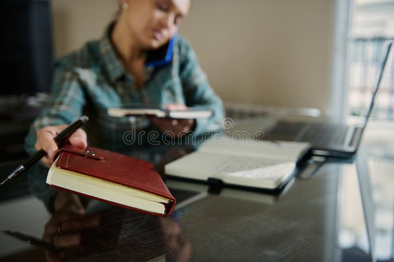 Woman Multitasking in a Modern Workspace with Notes and Laptop Stock ...