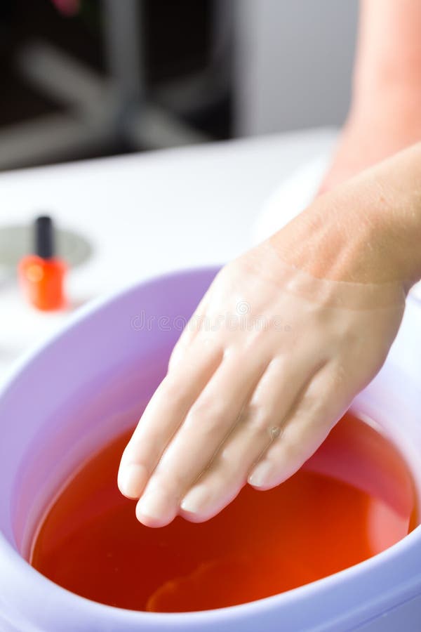 Female Hand Orange Paraffin Wax in Bowl. Manicure Beauty Spa Salon ...