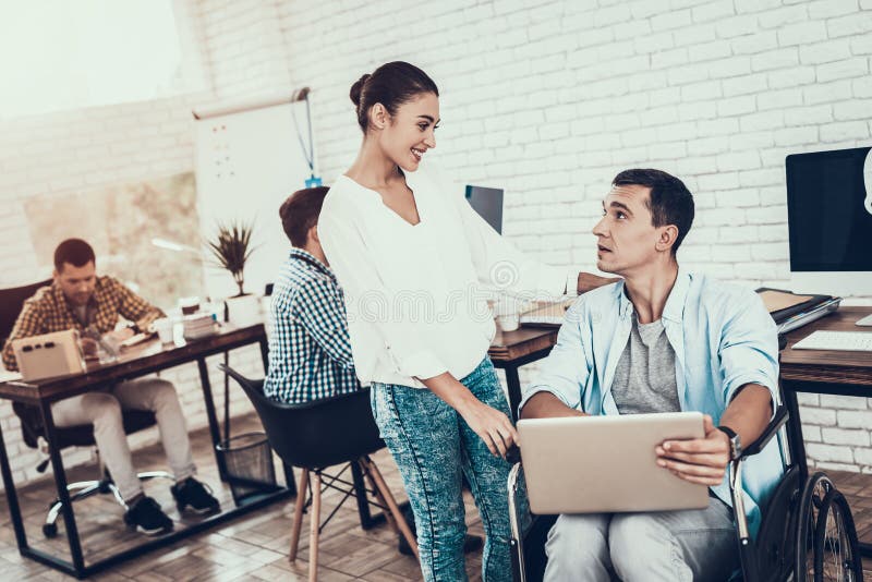 Woman Near Man On Wheelchair With Tablet In Office Stock Image Image