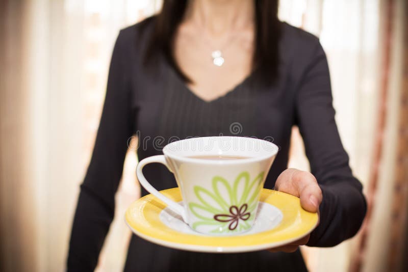 Woman Offering a Cup of Tea Blurring Stock Image - Image of giving ...