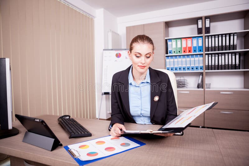 Woman in Office with a Chart Folder in Hands Stock Photo - Image of ...
