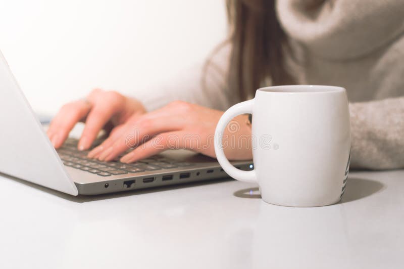 Woman in Office Typing on Notebook with a Cup Stock Photo - Image of ...
