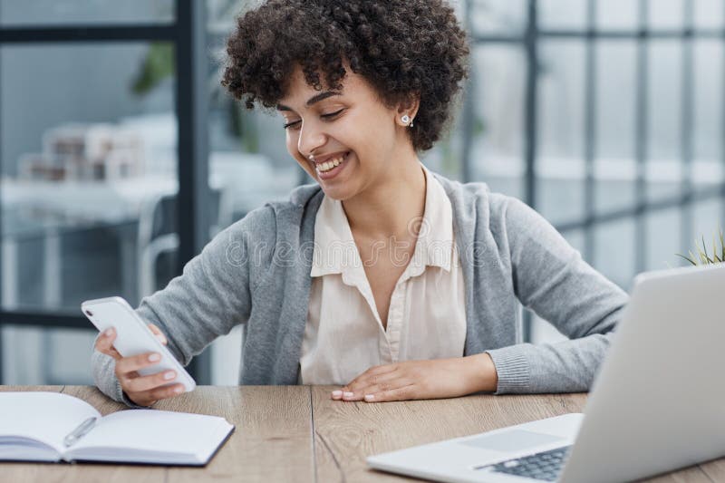 Woman in the Office Uses the Phone at the Workplace at the Computer ...