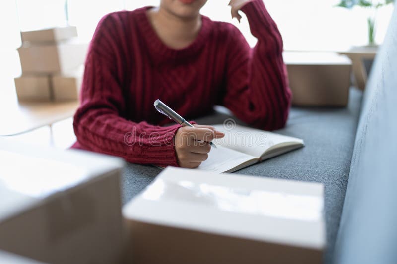 Woman, Online Seller, Using a Notebook Efficiently Manages Customer ...