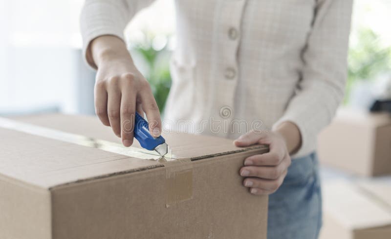 Woman Opening a Box Using a Cutter Stock Photo - Image of opening ...