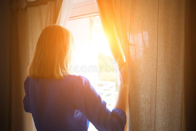 Woman opening curtains stock image. Image of looking - 285800511