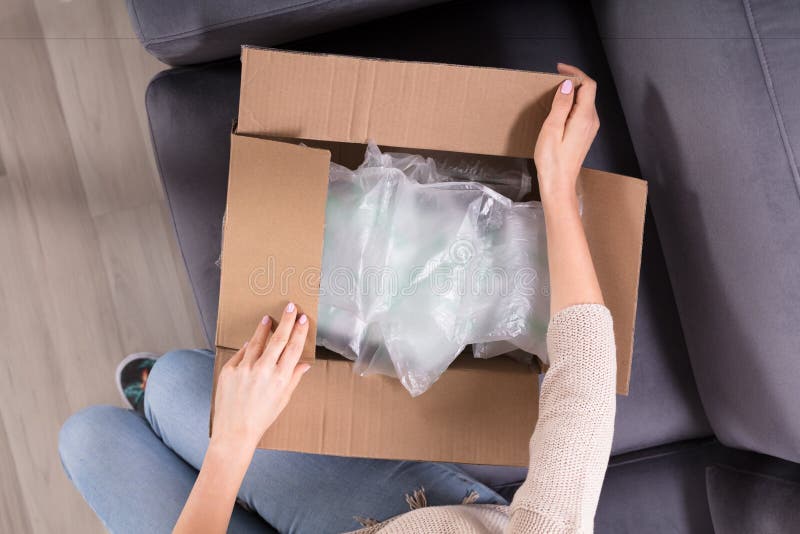 Woman Opening Delivered Parcel Stock Photo - Image of human, female ...
