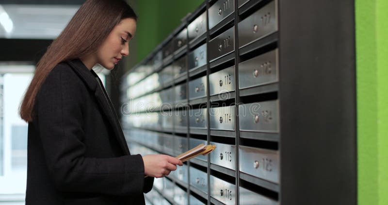 Woman Opening Postbox and Taking Mail for Her Apartment. Mail Shipping ...