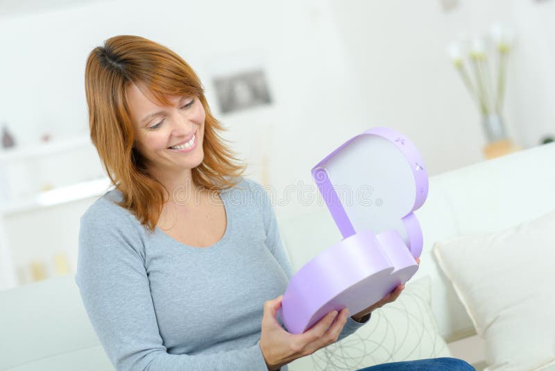 Woman opening a present stock photo. Image of special - 310493258