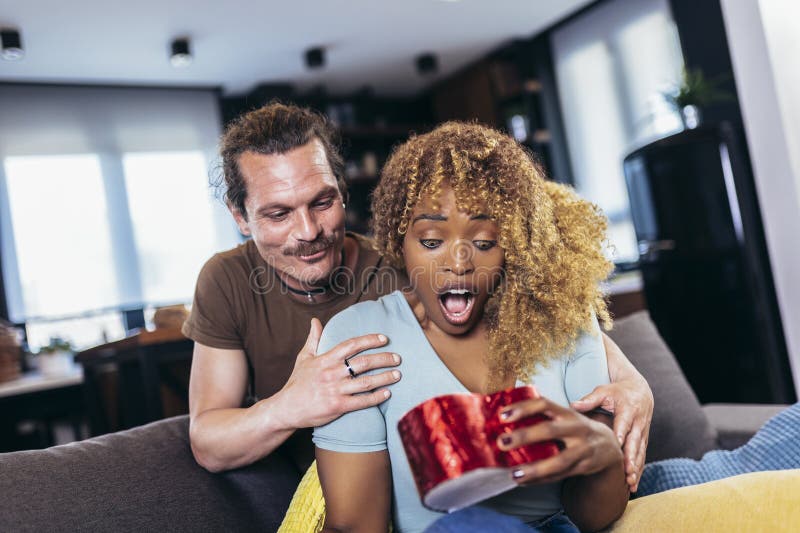 Woman Opening a Present Her Boyfriend Bought Her for Their Anniversary ...