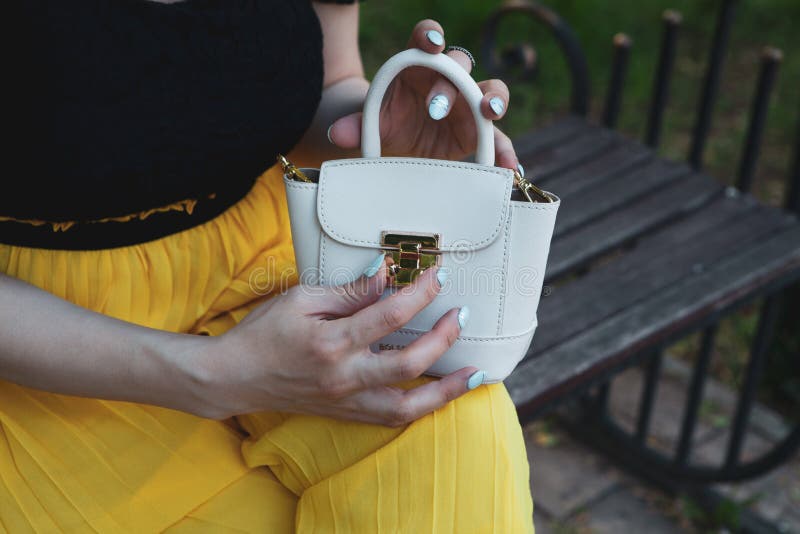 Woman Opens a Bag while Sitting on a Bench Stock Image - Image of ...