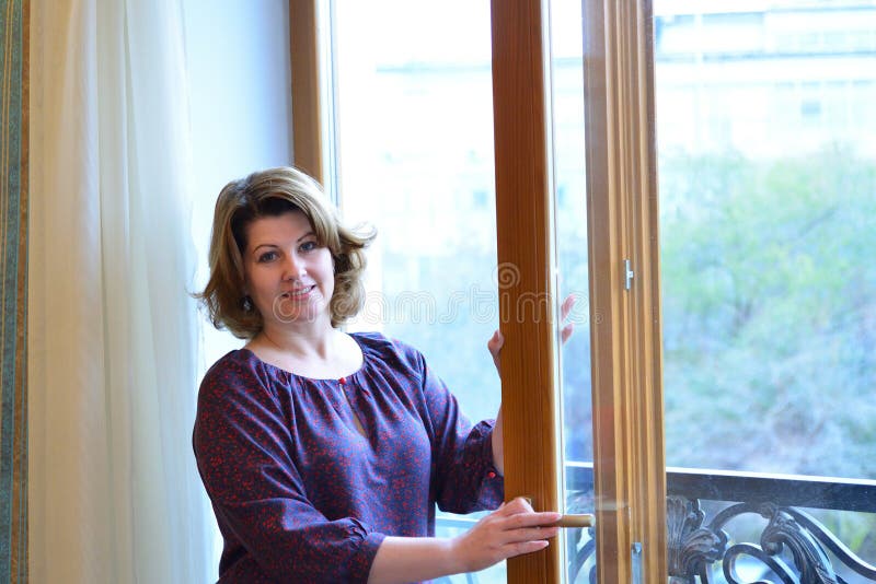 Woman Opens or Closes Window To Balcony Stock Image - Image of fence ...