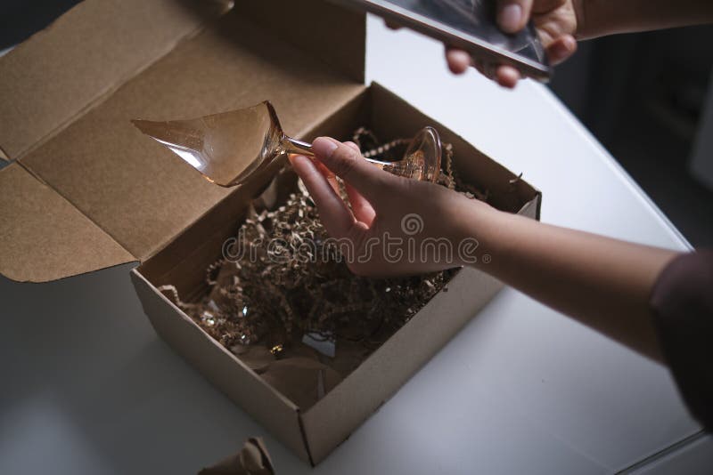 Woman Opens a Delivery Box from a Store and Discovers a Broken Glass ...