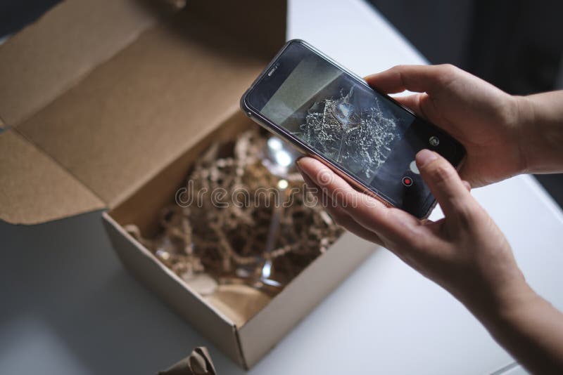 Woman Opens a Delivery Box from a Store and Discovers a Broken Glass ...