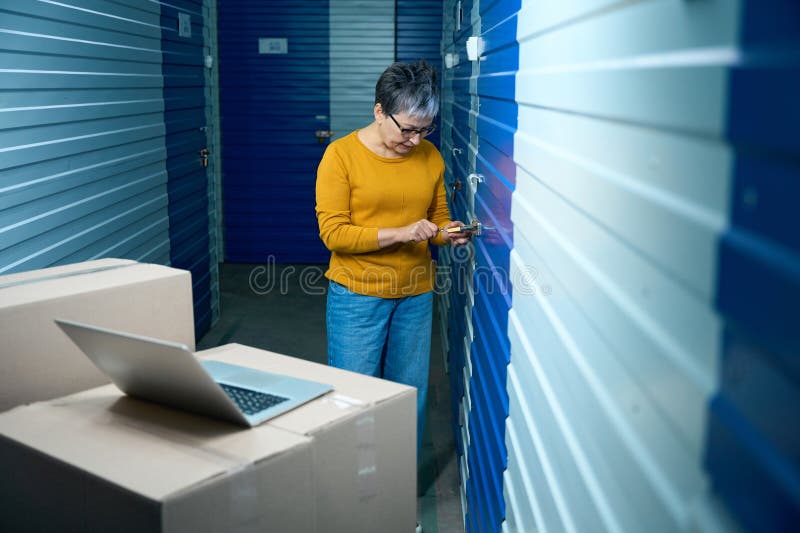 Woman Opens Storage Locker Next To Boxes Stock Image - Image of married ...