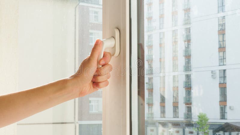 Woman Opens a Window. the Hand Holds the Window Opening Handle Stock ...