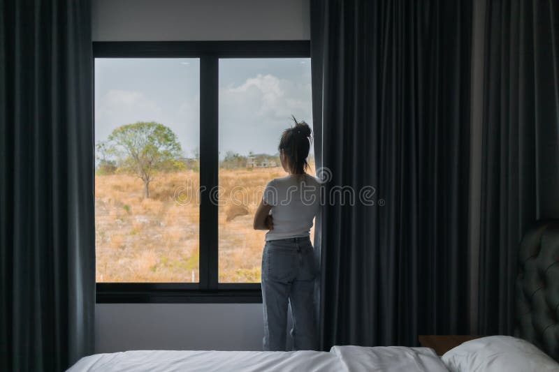 Woman Opens Windows Curtain of Bedroom and Checking the View. Stock ...