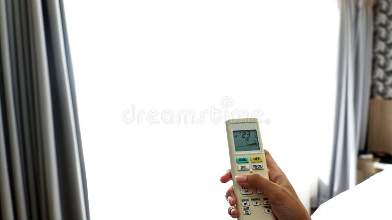 Woman Operating Remote Controller on Air Conditioner Inside the Room ...